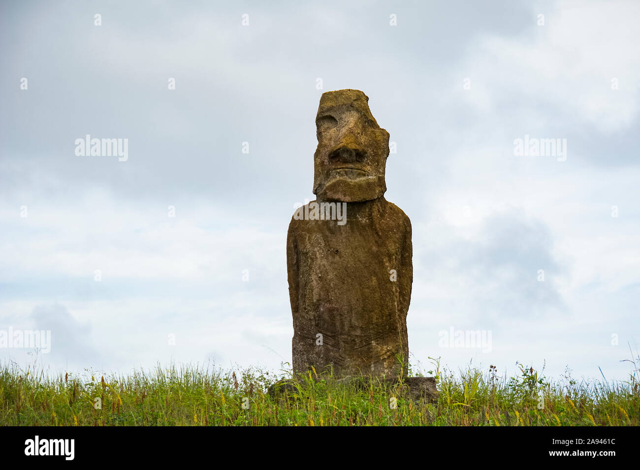 A single moai on its platform against a grey sky, Hanga roa; Easter ...