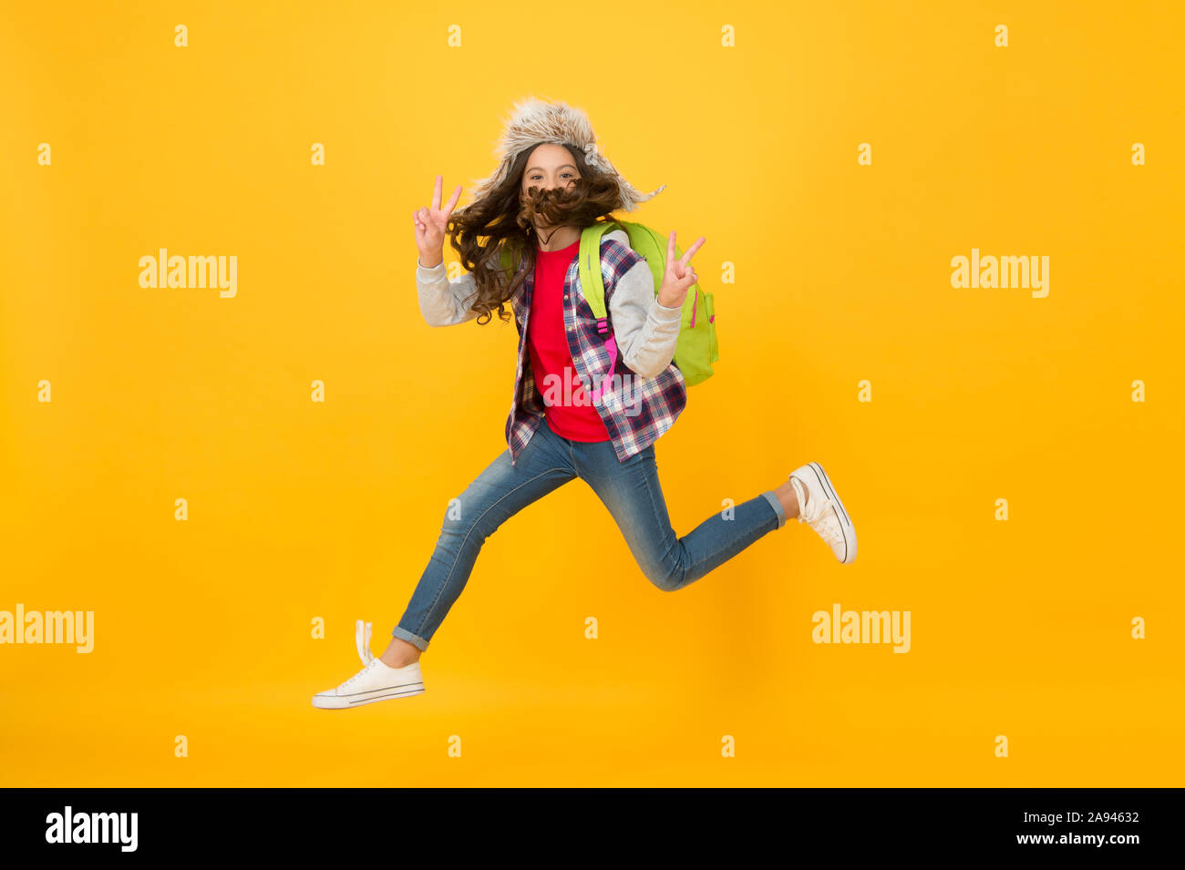Leaping in air. Energetic little child in motion yellow background ...