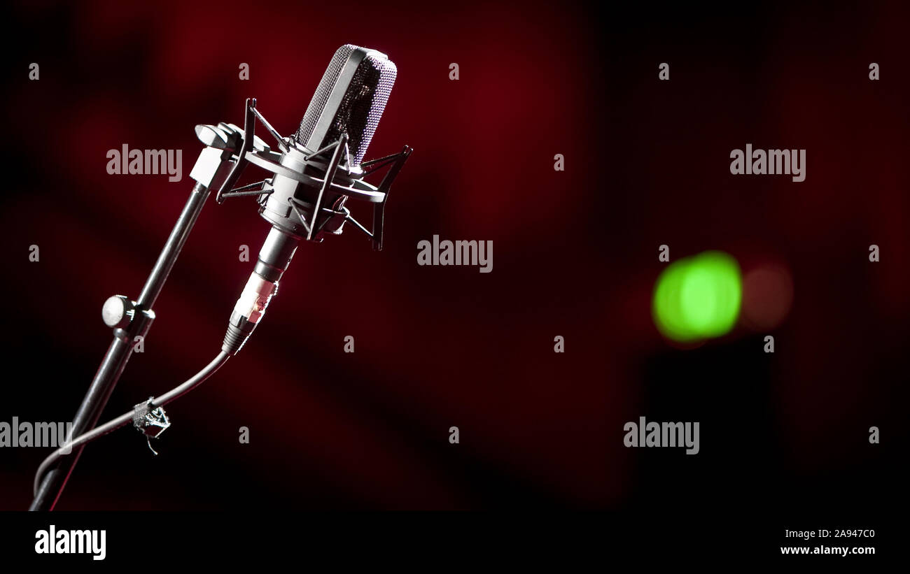 Recording light on green. Shallow focus on a stand mounted condenser ...