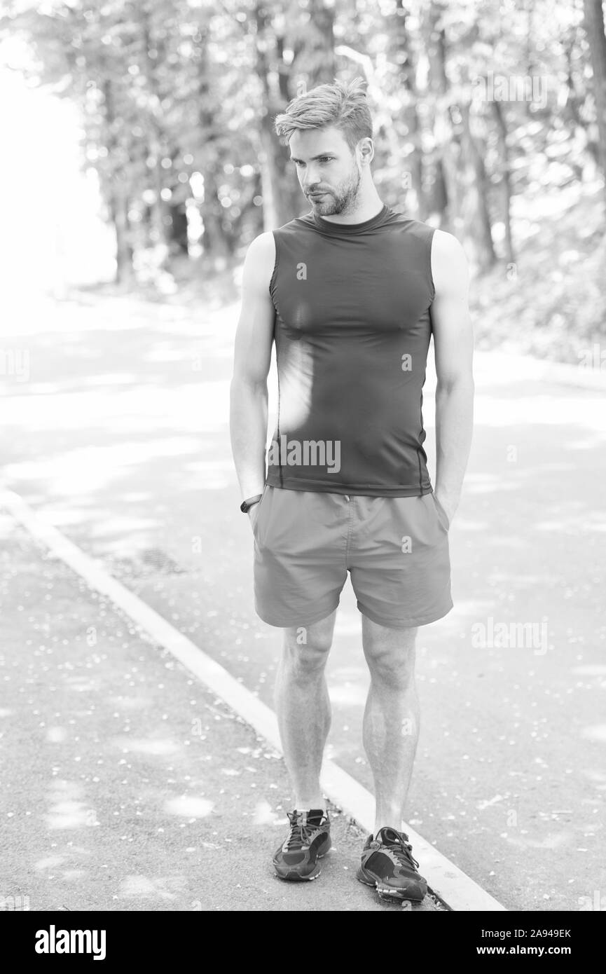 Handsome sportsman in sportswear outdoors. Active sportsman training ...