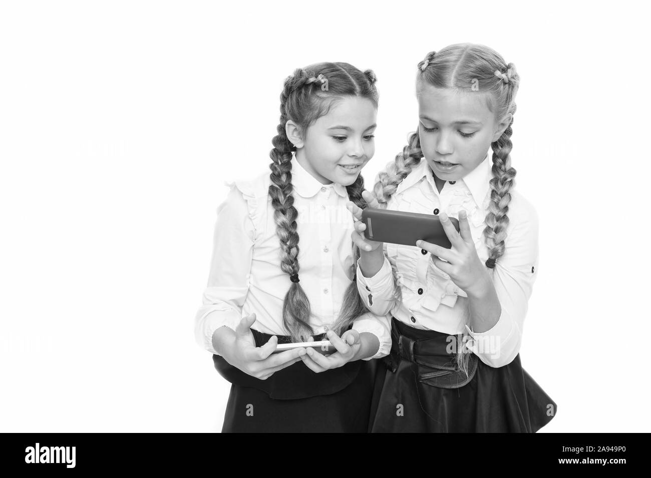 Future is here. Little schoolgirls using smartphones isolated on white ...