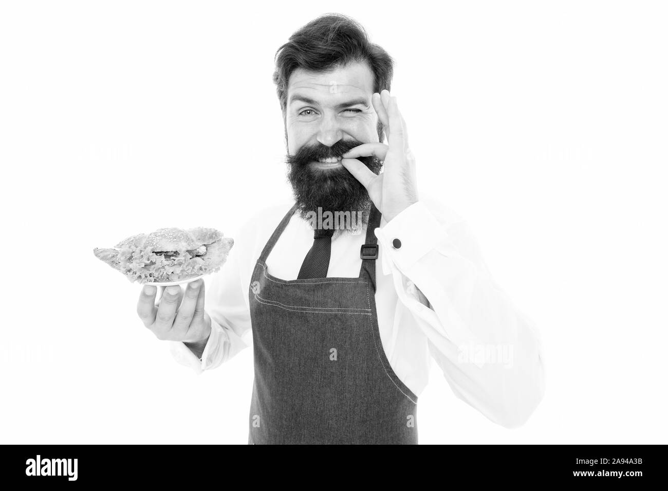 Guy serving croissant stuffed with lettuce and fresh vegetables. Cafe ...