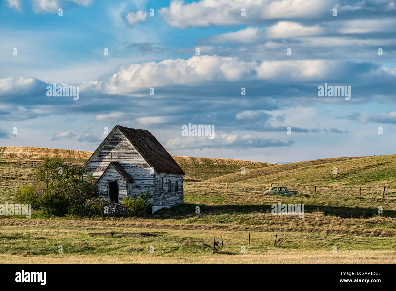 Old, abandoned country church weathered from the years on the prairies ...