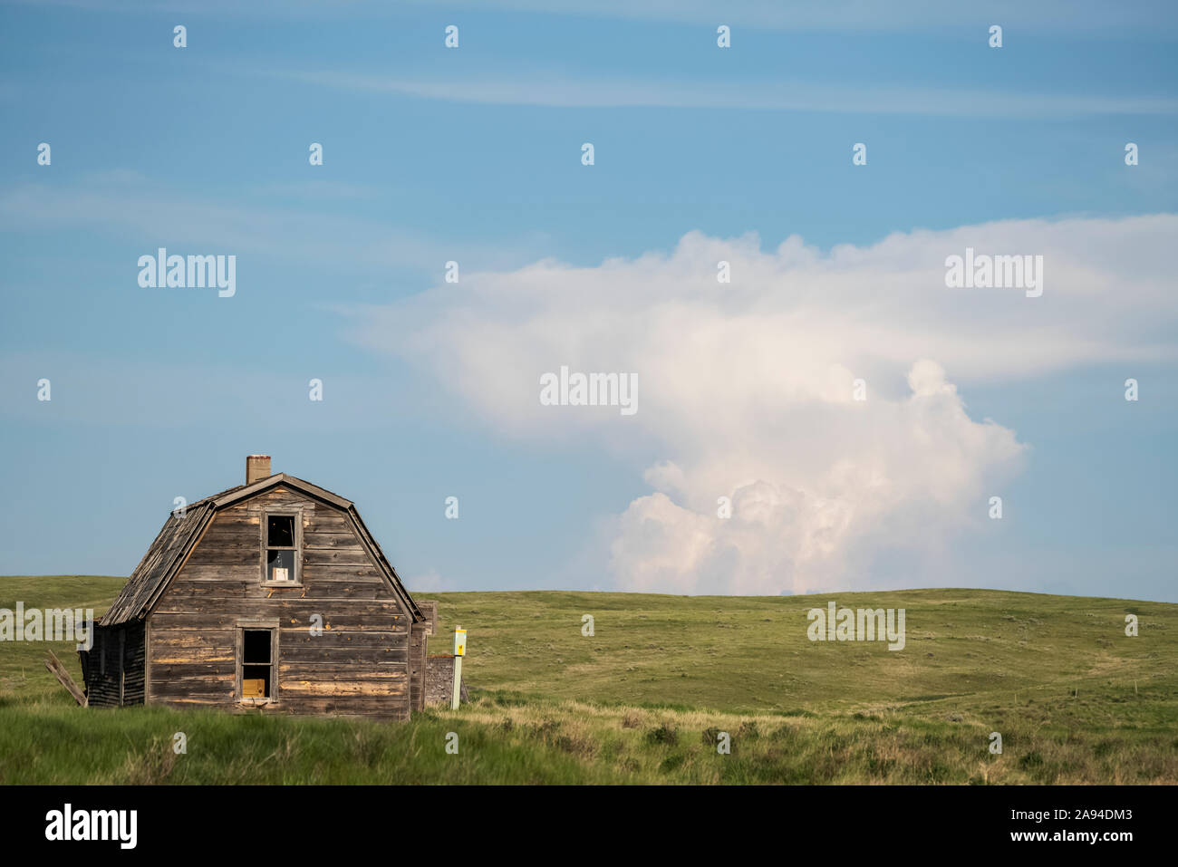 Abandoned barn on farmland with unique cloud formation in the distance ...