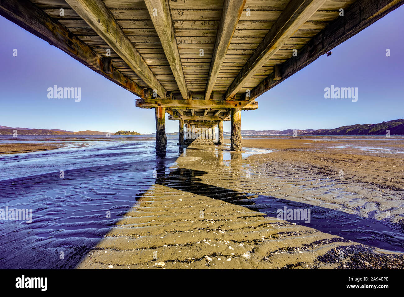 Underside of the Petone wharf with wet sand; Petone, Wellington Region ...