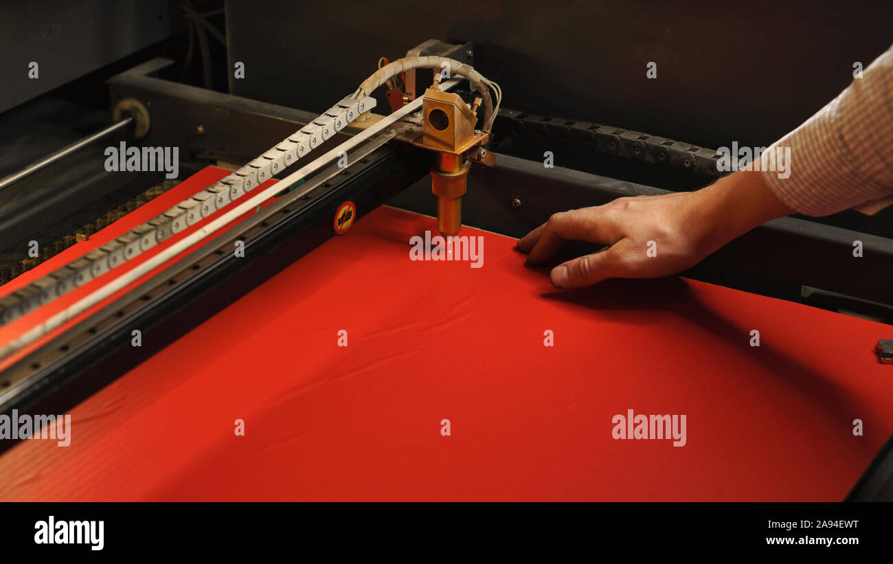 Laser cutting beam high precision on a paperboard. Modern machine ...