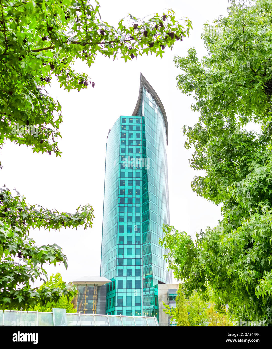 High-rise residential building with green facade, rectangular windows ...
