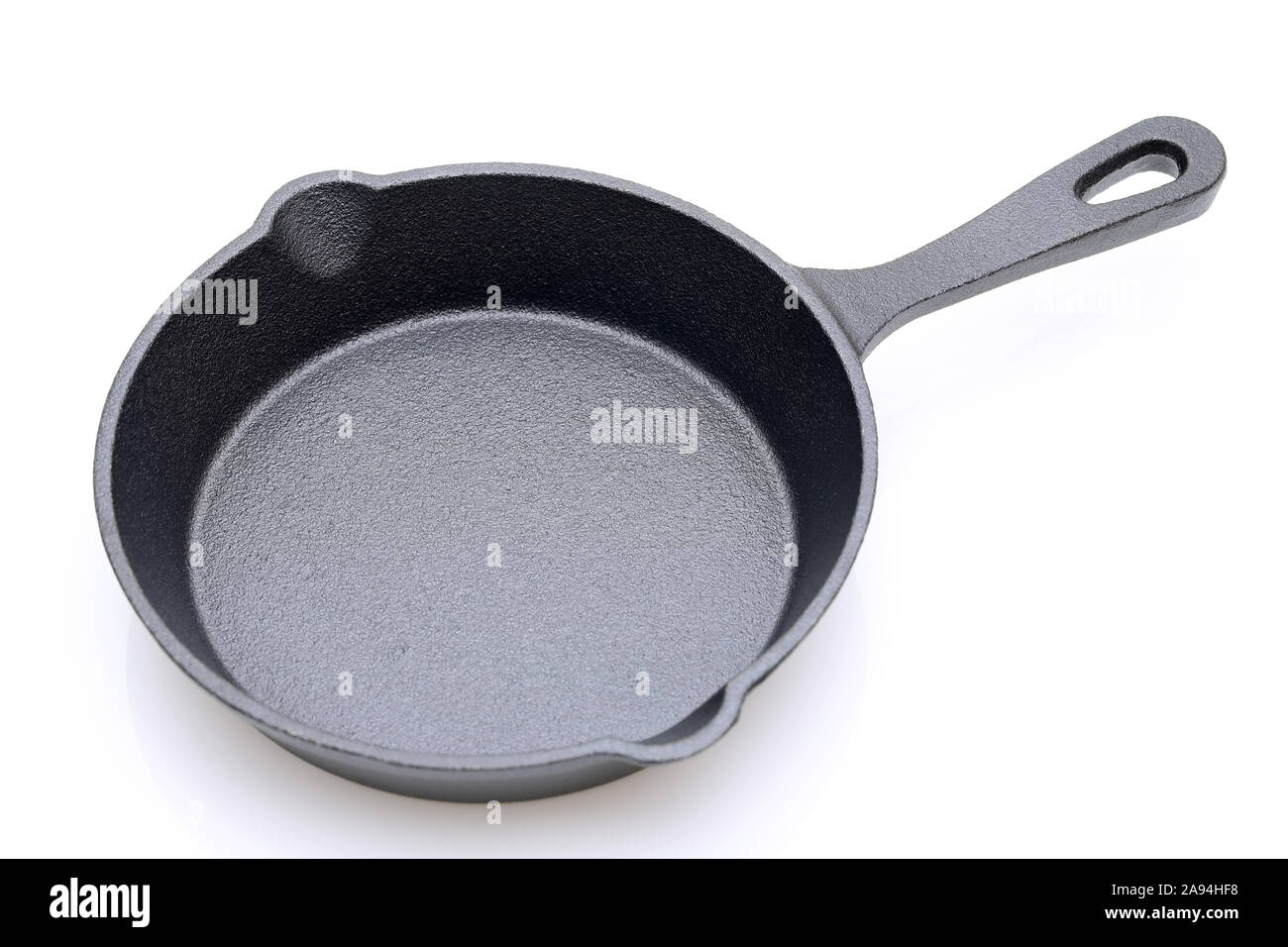 Empty small iron frying pan on a white background Stock Photo - Alamy