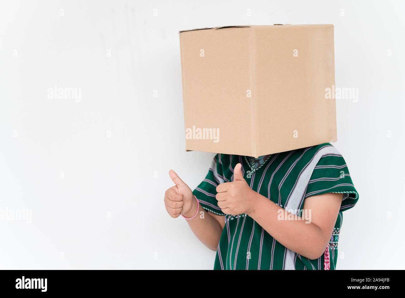 Young boy over isolated white background holding a box to move it to ...