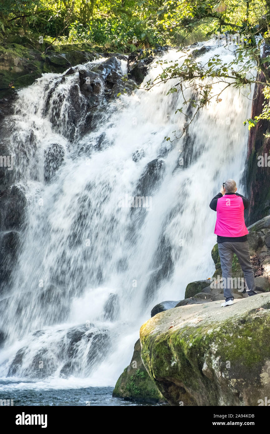 A tourist views the upper Cascada de Texolo waterfall near Xico ...