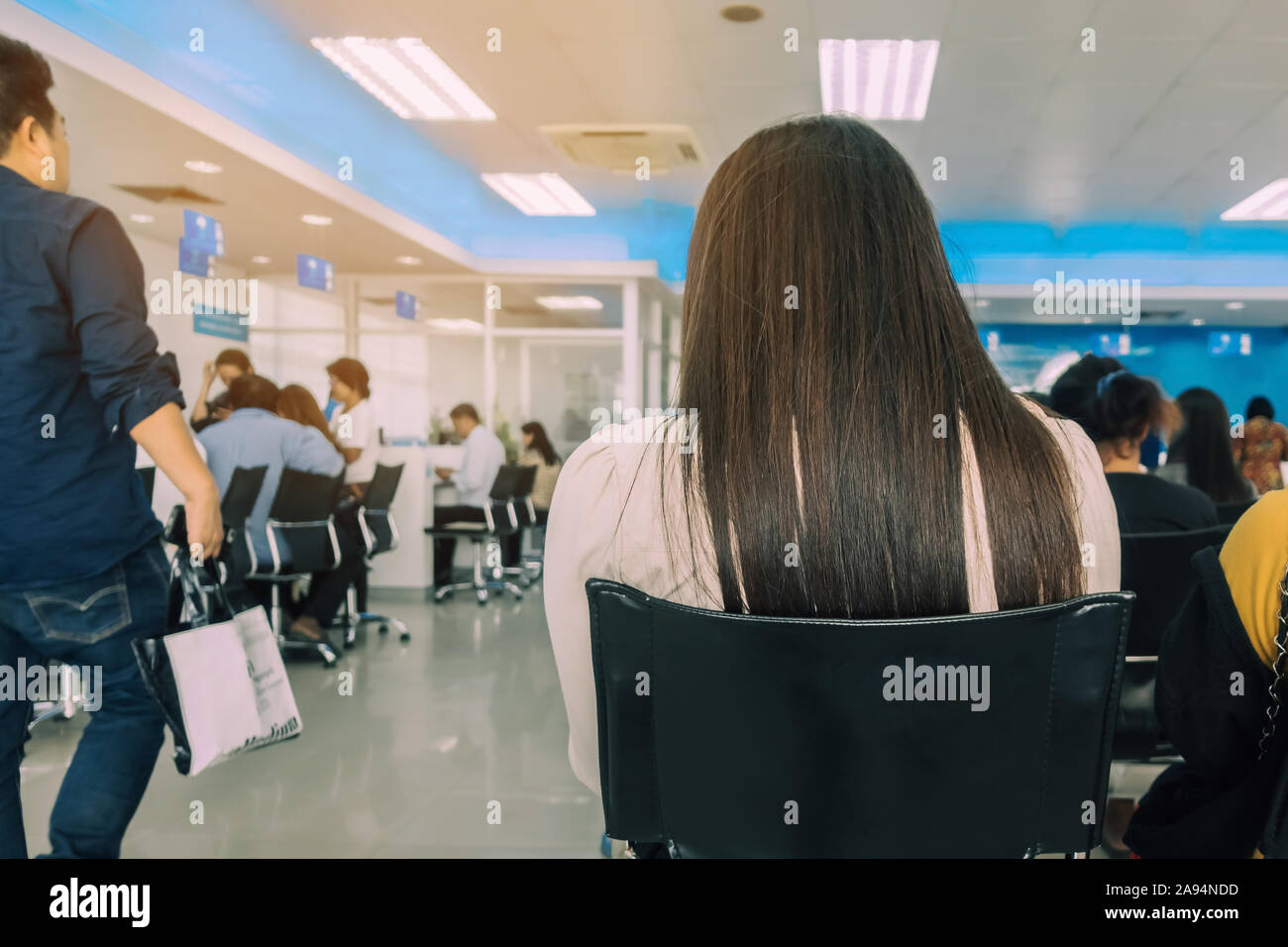 Back view of people sit and waiting in financial transactions in the ...