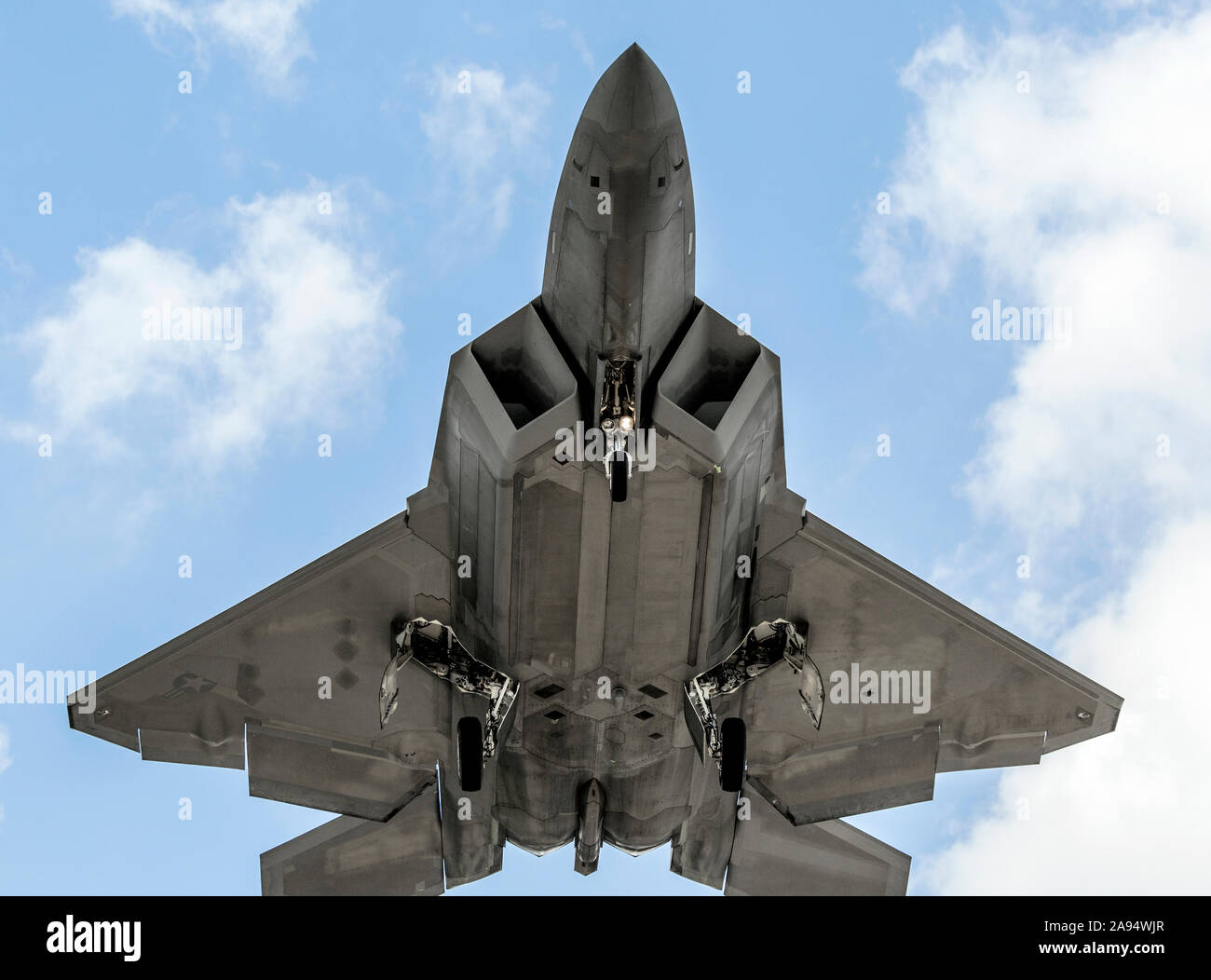 A United States Air Force F-22 Raptor comes in for a landing overhead ...