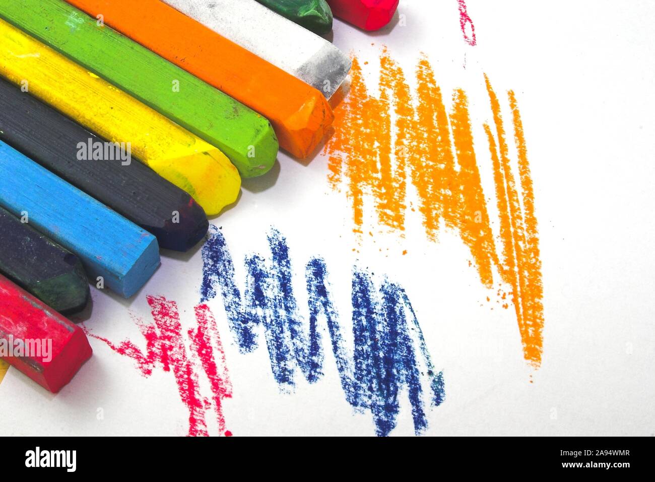 strokes of pastel crayons and crayons in different colors on a white ...
