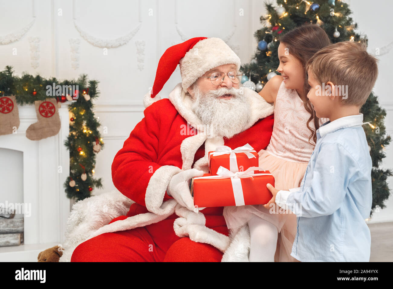 Santa Claus with kids indoors christmas celebration concept Stock Photo ...