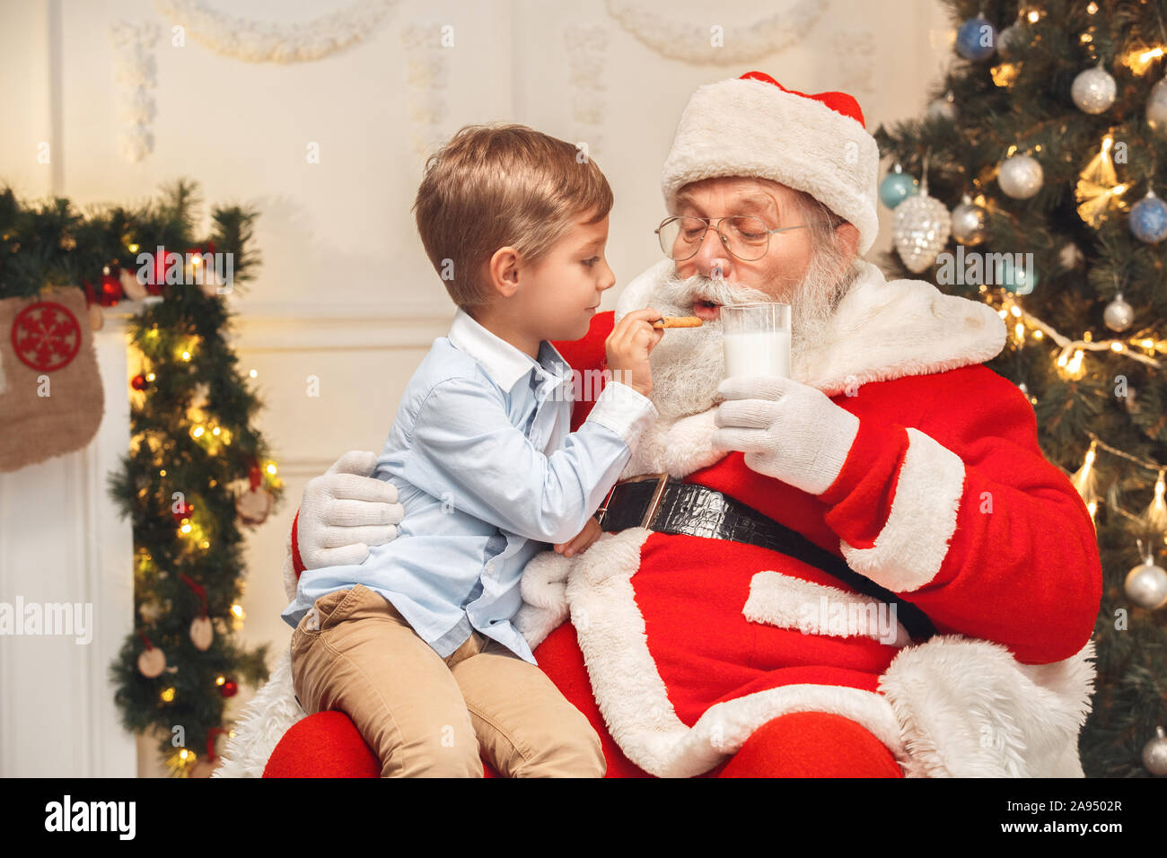 Santa Claus with kids indoors christmas celebration concept Stock Photo ...