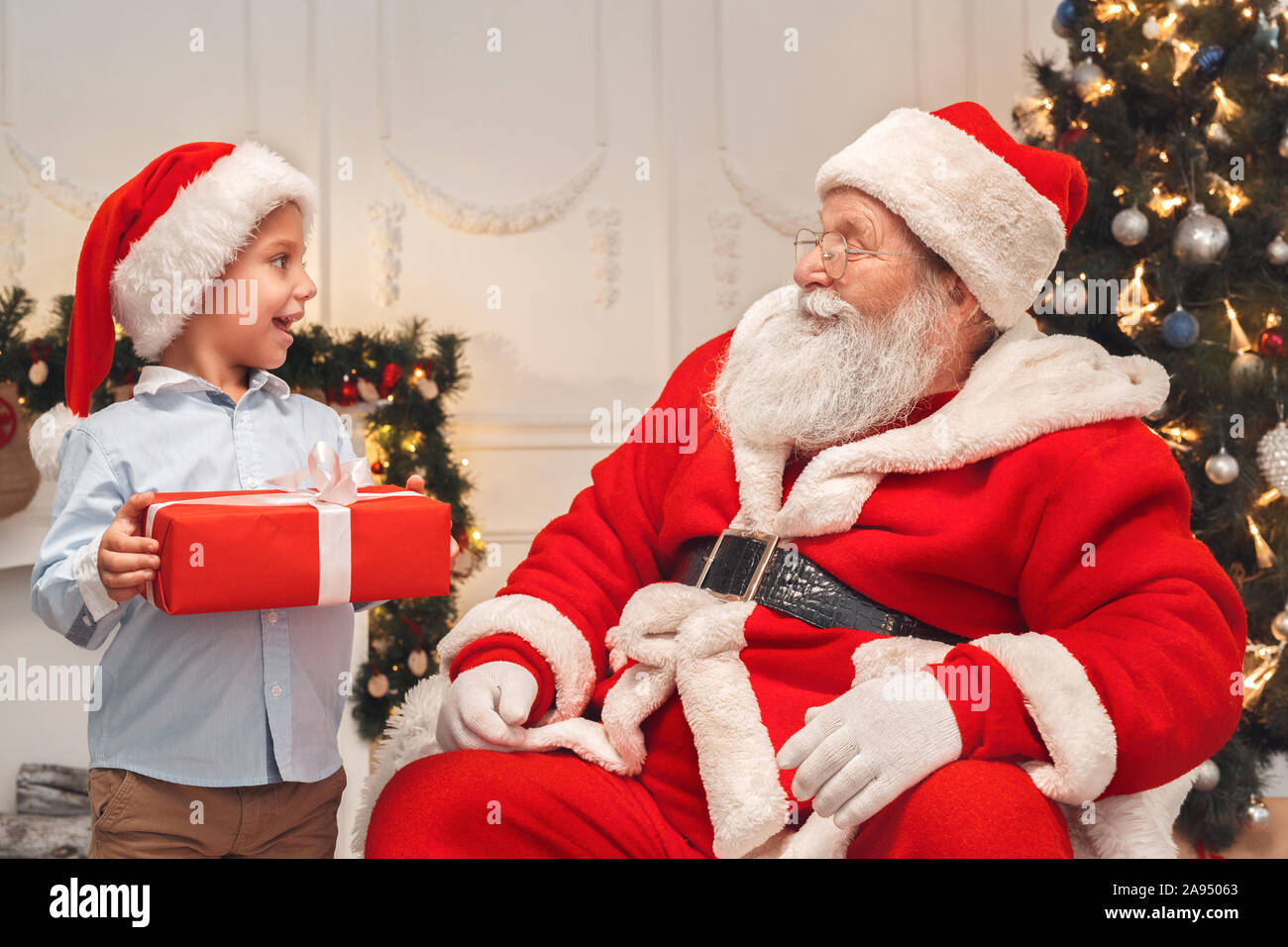 Santa Claus with kids indoors christmas celebration concept Stock Photo ...