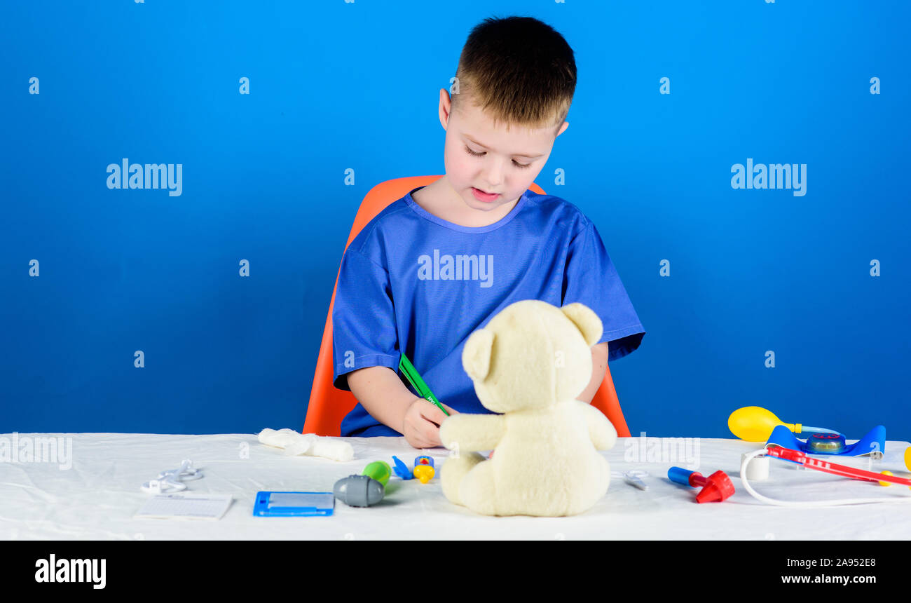pediatrician intern. little boy in medical uniform. kid doctor with ...