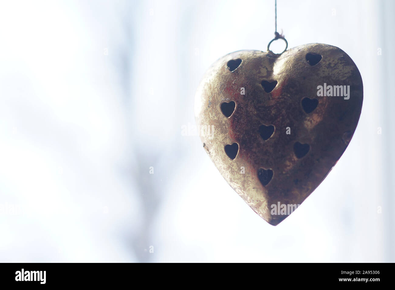 Heart with heartshaped holes in window Stock Photo - Alamy