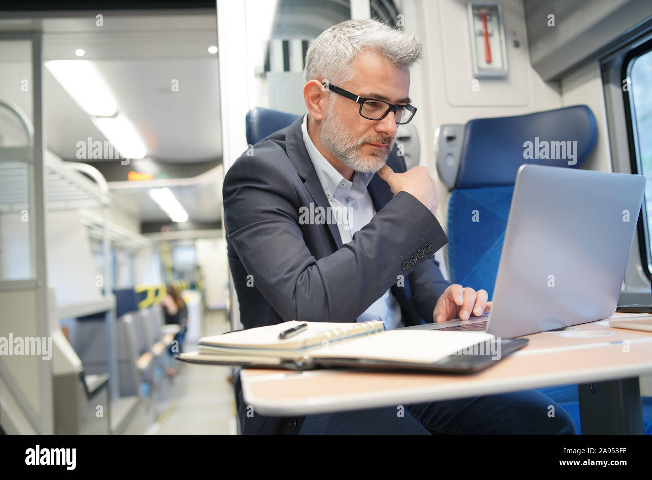 Man laptop train busy hi-res stock photography and images - Alamy