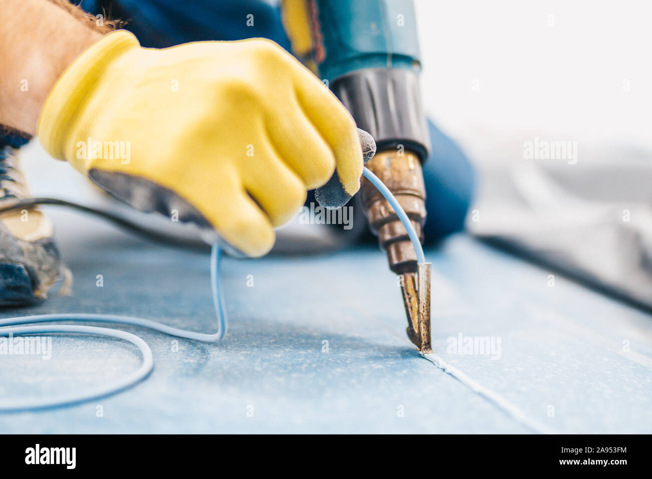 Master welding machine type construction dryer solders two pieces of ...