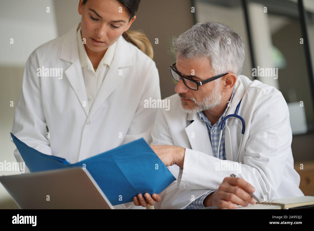 Medical people working together on patient file, hospital office Stock ...