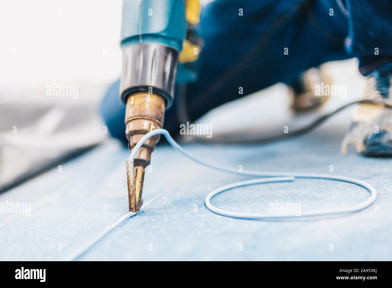 Master welding machine type construction dryer solders two pieces of ...