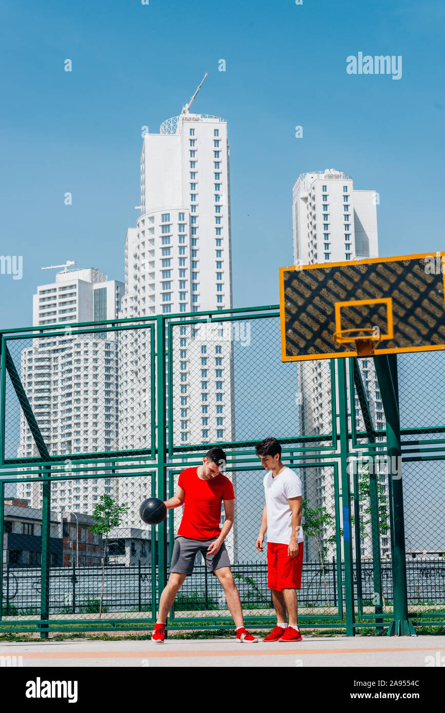 Basketball players playing ball(pushing, dribbling) on an urban ...
