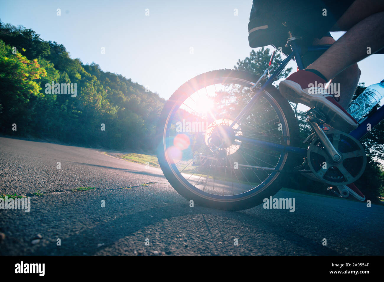 Fit male biker cyclist riding his bike cycle on an asphalt road at ...