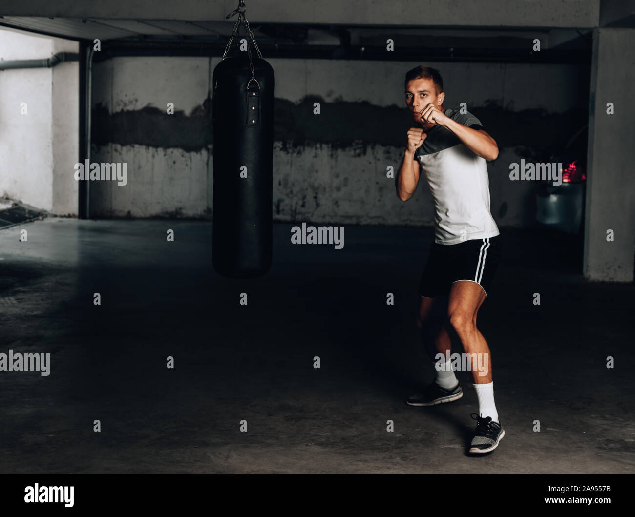 Focused muscular boxer man kickboxing hi-res stock photography and ...