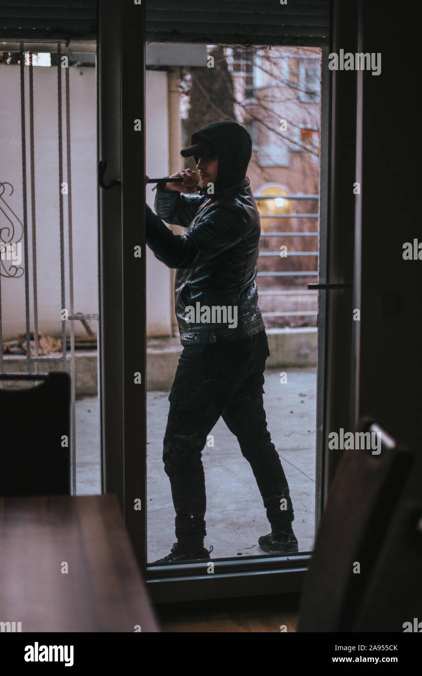 Burglar entering through window hi-res stock photography and images - Alamy