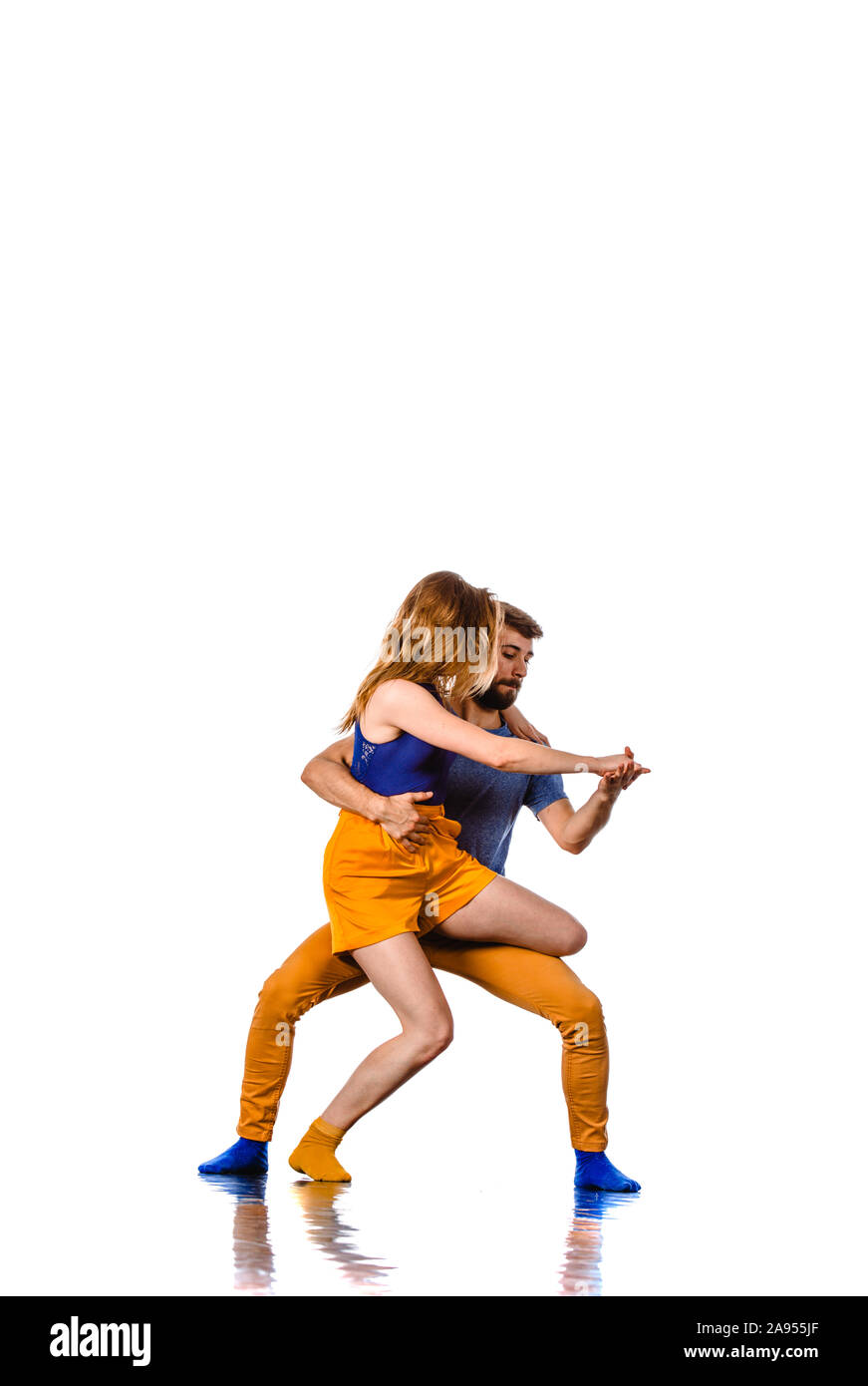 Two hip hop male and female break dancers dancing on white background ...