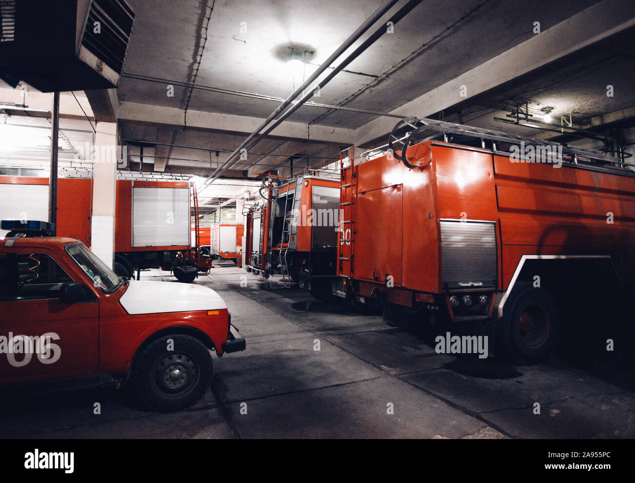 Multiple fire trucks parked in a garage used for firefighting ...
