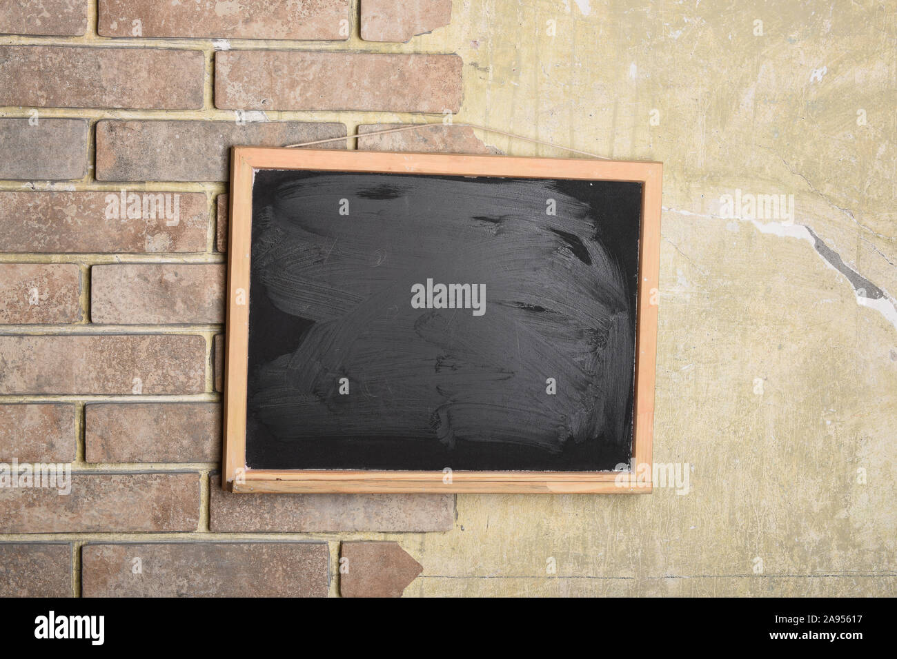 textured pastel and brick wall background and blackboard in wooden ...