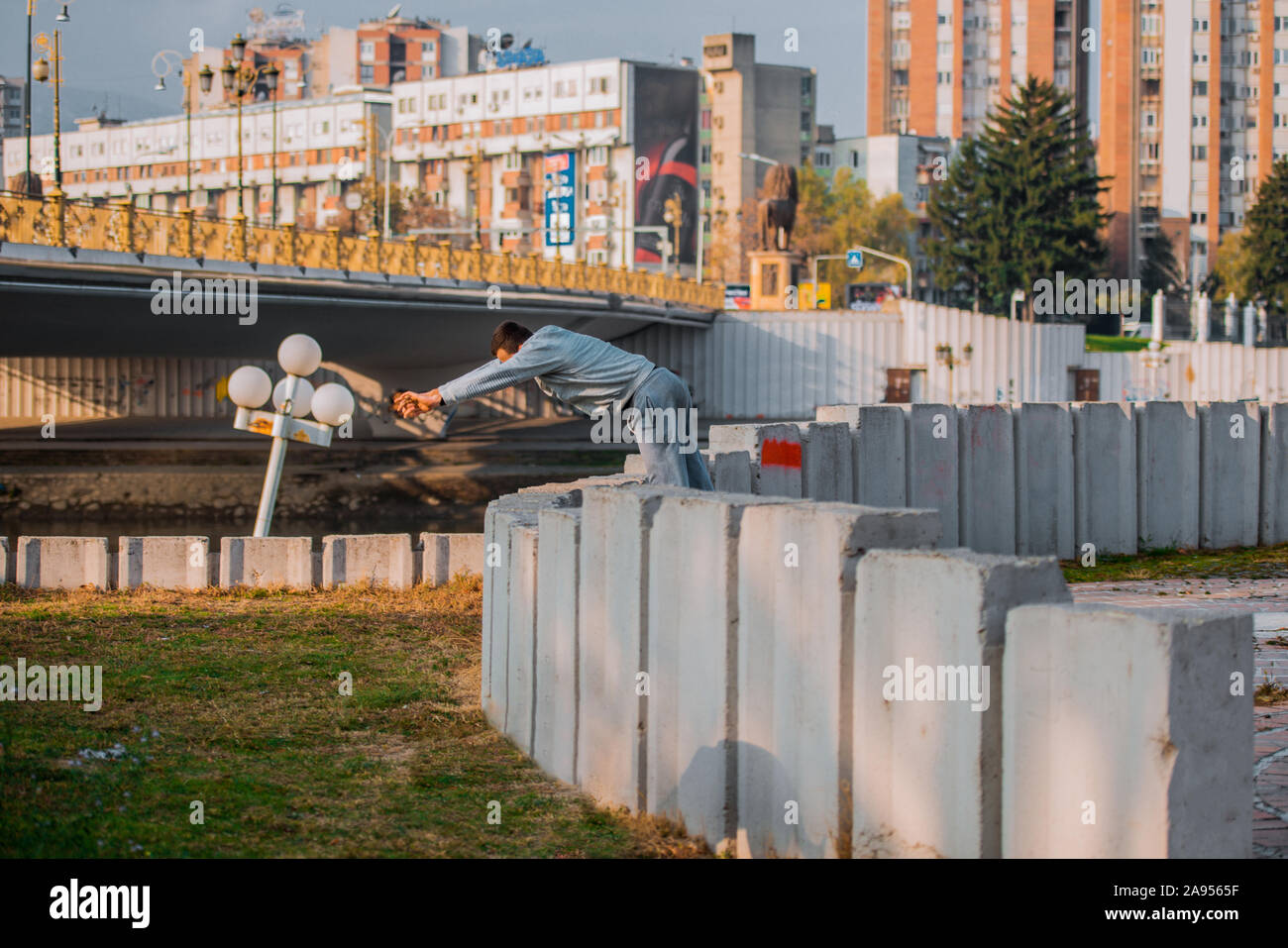 Free runner practicing jumping over concrete obstacles in park Stock ...