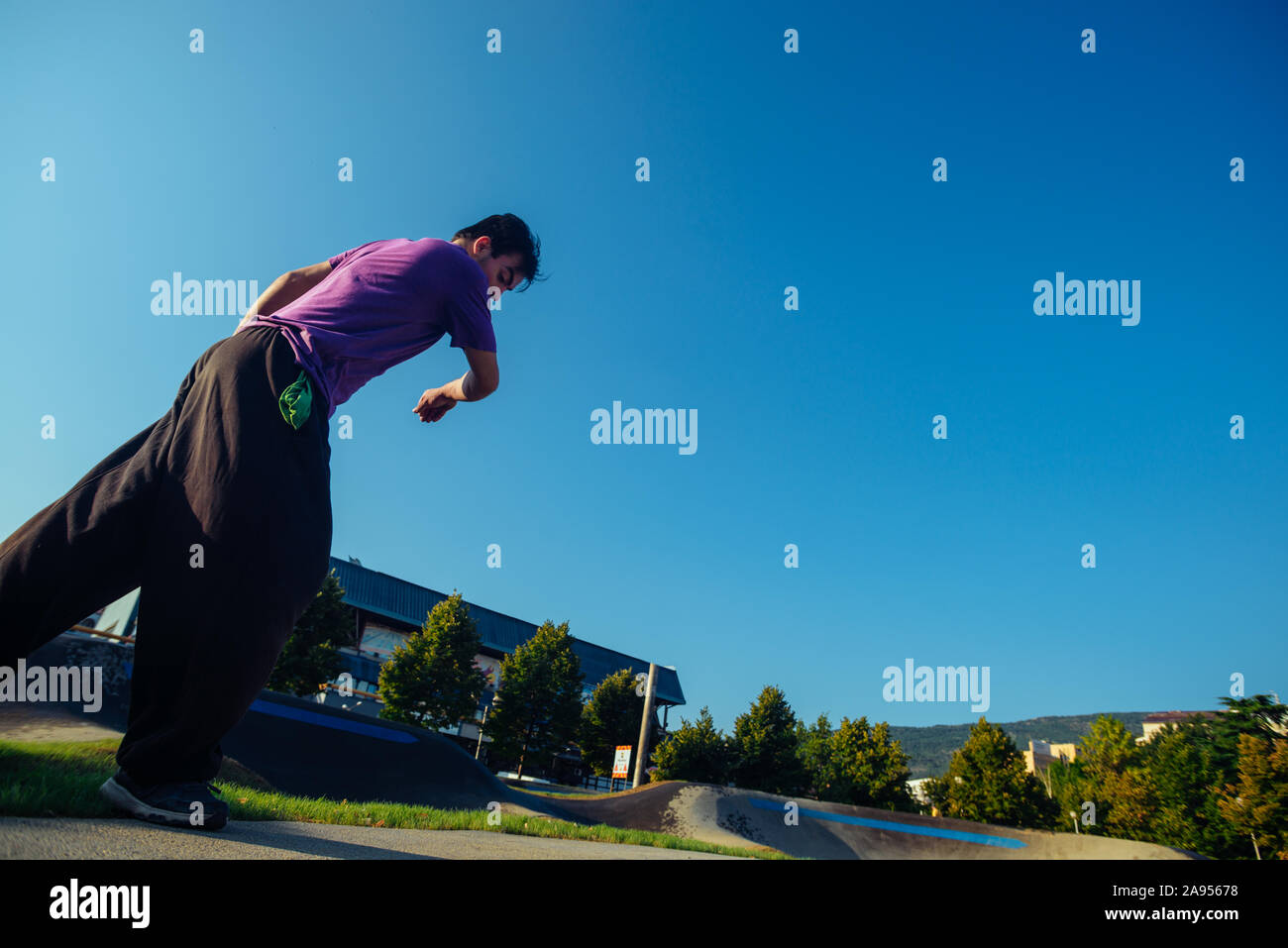 Acrobat practicing parkour exercises at the local skatepark Stock Photo ...