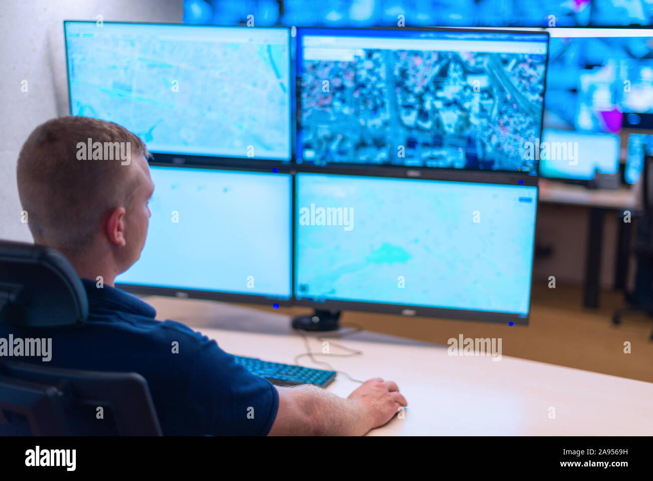 Male operator watching the cctv monitors Stock Photo - Alamy