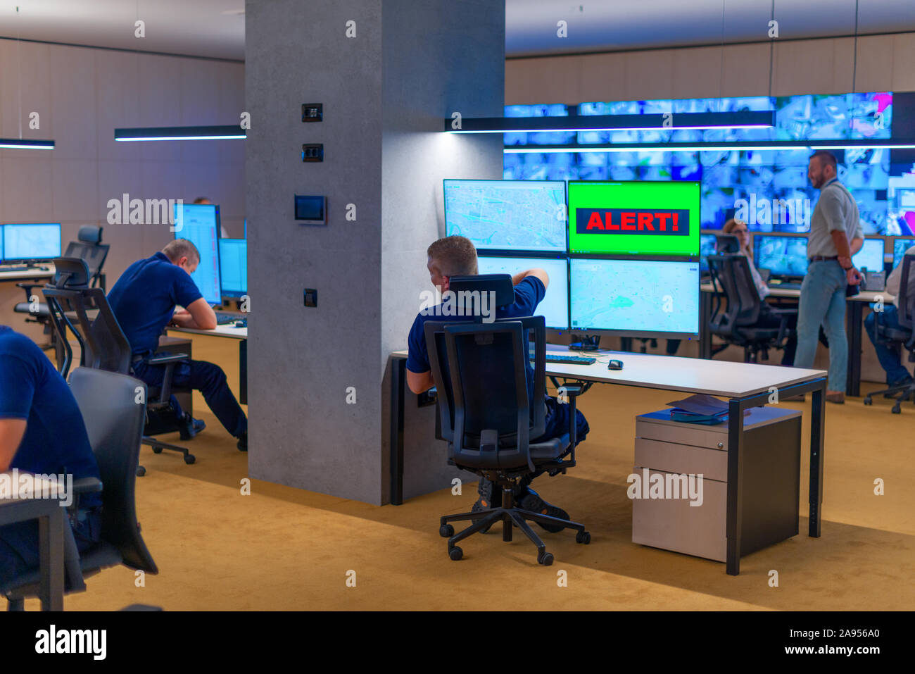 Male computer operator monitoring from a security ( computer, logistic ) center Stock Photo - Alamy