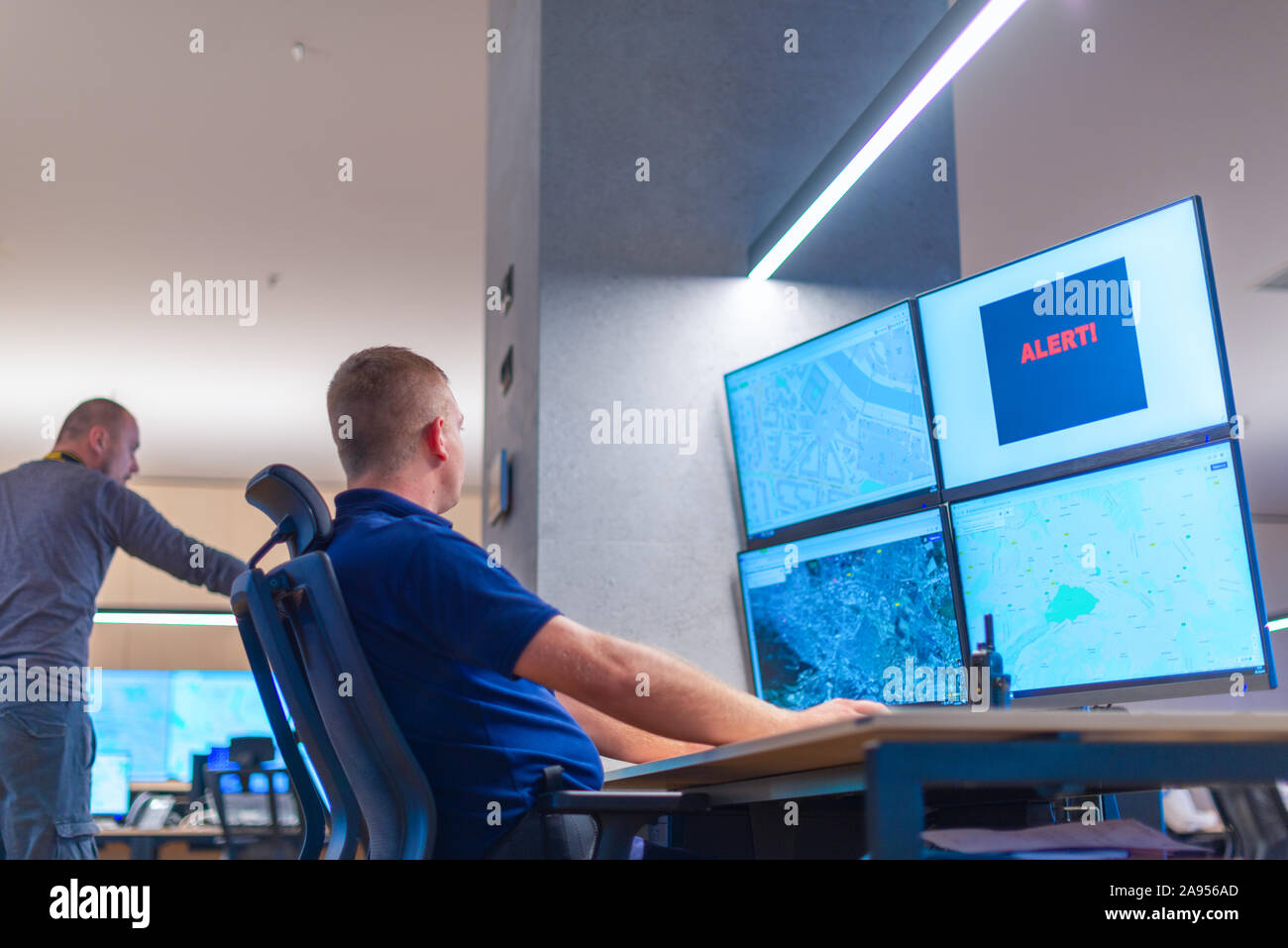 Male computer operator monitoring from a security ( computer, logistic ) center Stock Photo - Alamy