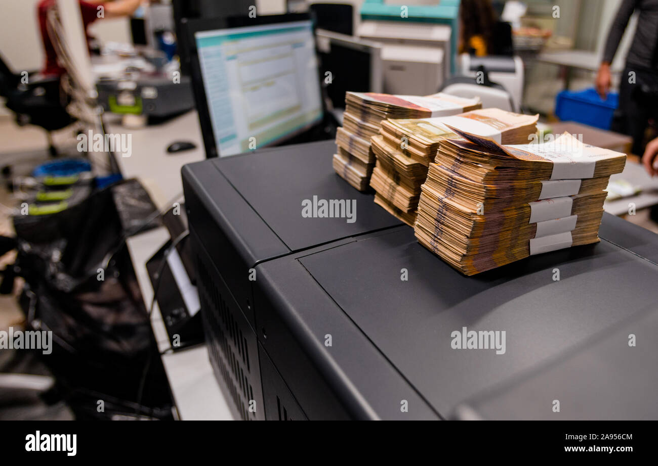 Bundles of banknotes divided into groups with currency straps placed on ...