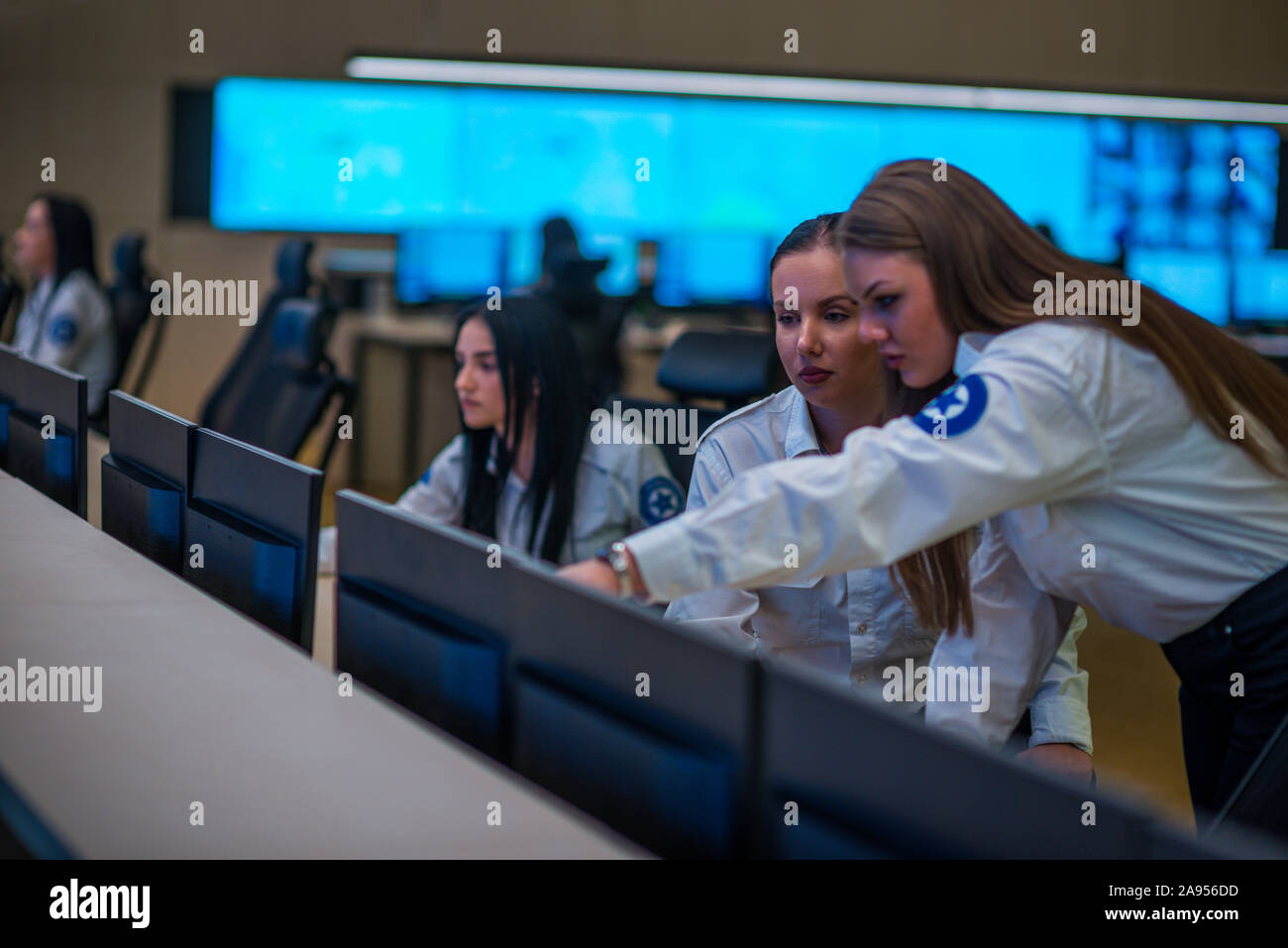 Security guard monitoring modern CCTV cameras in a surveillance room ...