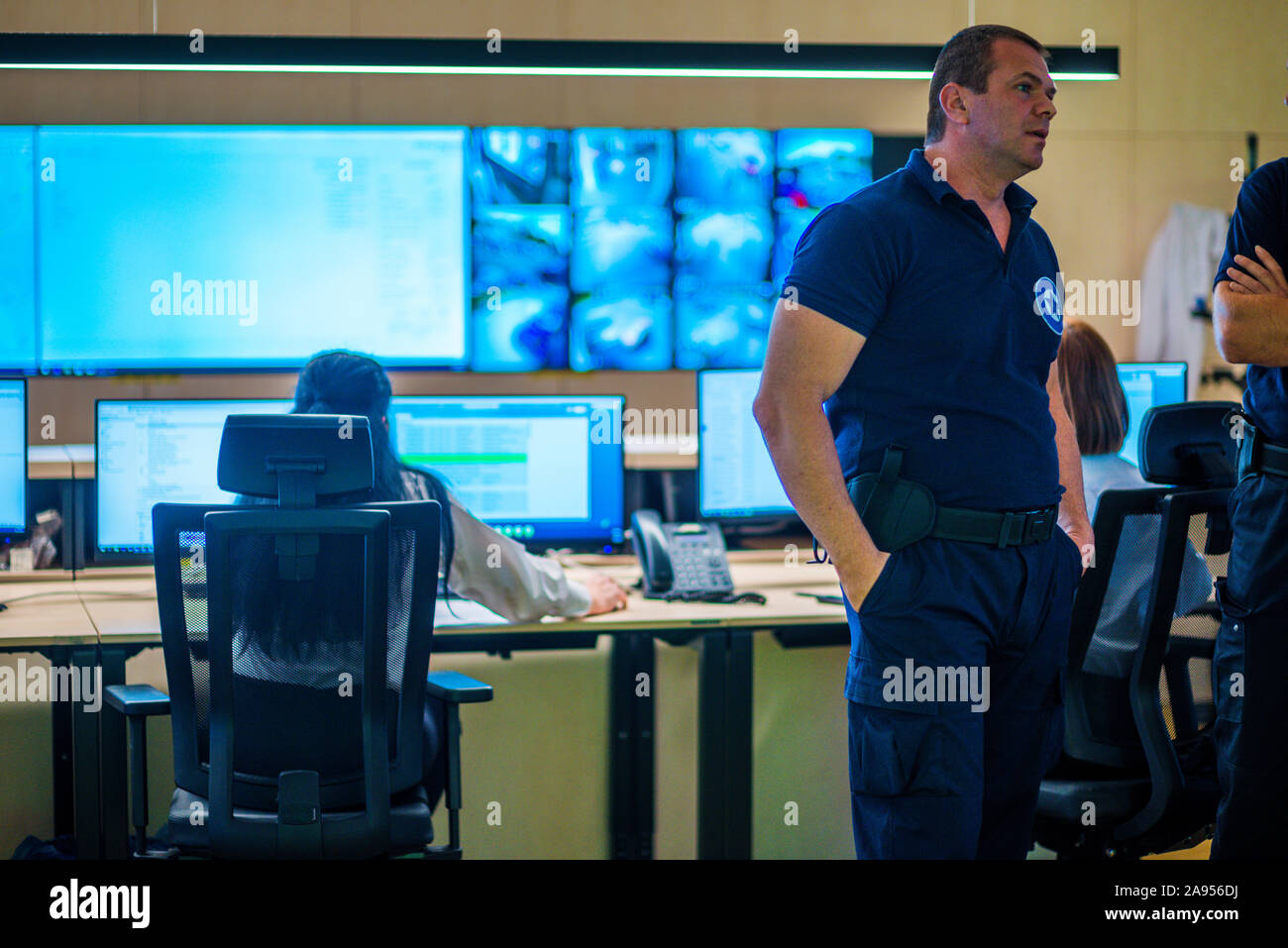 Security guards and policemen holdng portable transmitter having ...