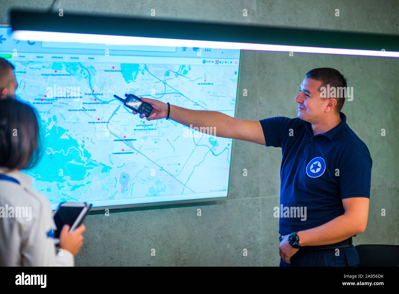 Security guards and policemen holdng portable transmitter having ...