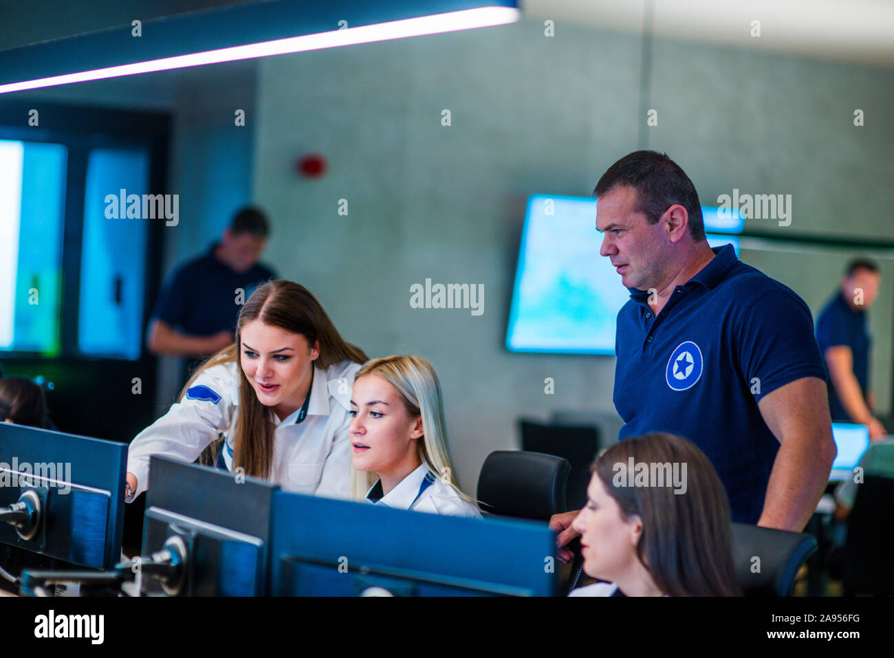 Security guards working in surveillance room, monitoring cctv and ...