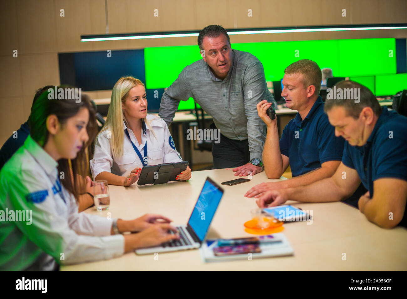 Security guard monitoring modern CCTV cameras in a surveillance room ...