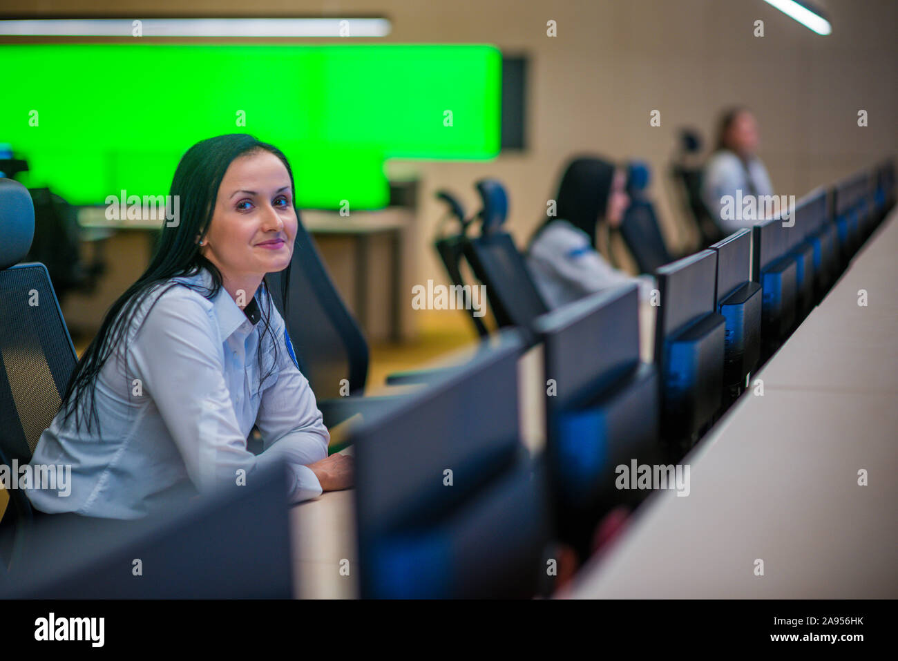 Security guard monitoring modern CCTV cameras in a surveillance room ...