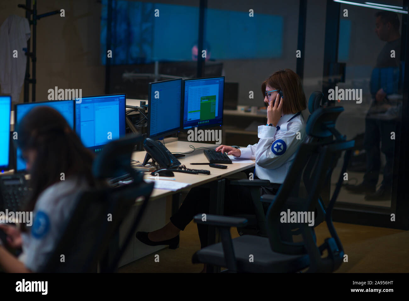 Security guard monitoring modern CCTV cameras in a surveillance room ...