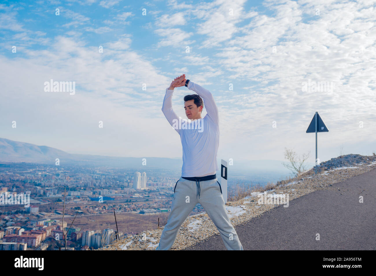 Fit male stretching and performing his morning routines while wearing a ...