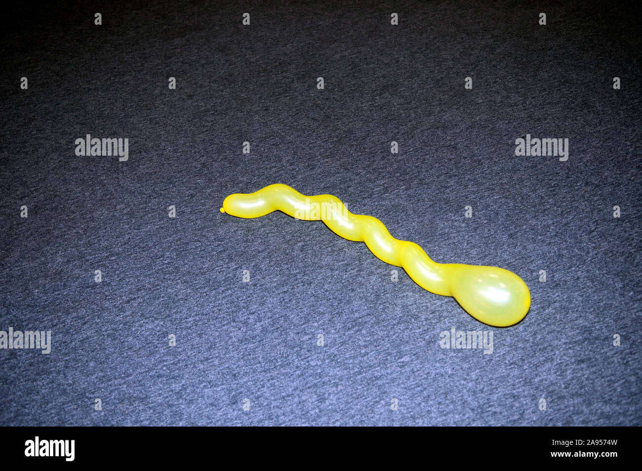 An Inflated Yellow Party Balloon On A Carpeted Office Floor Stock Photo ...
