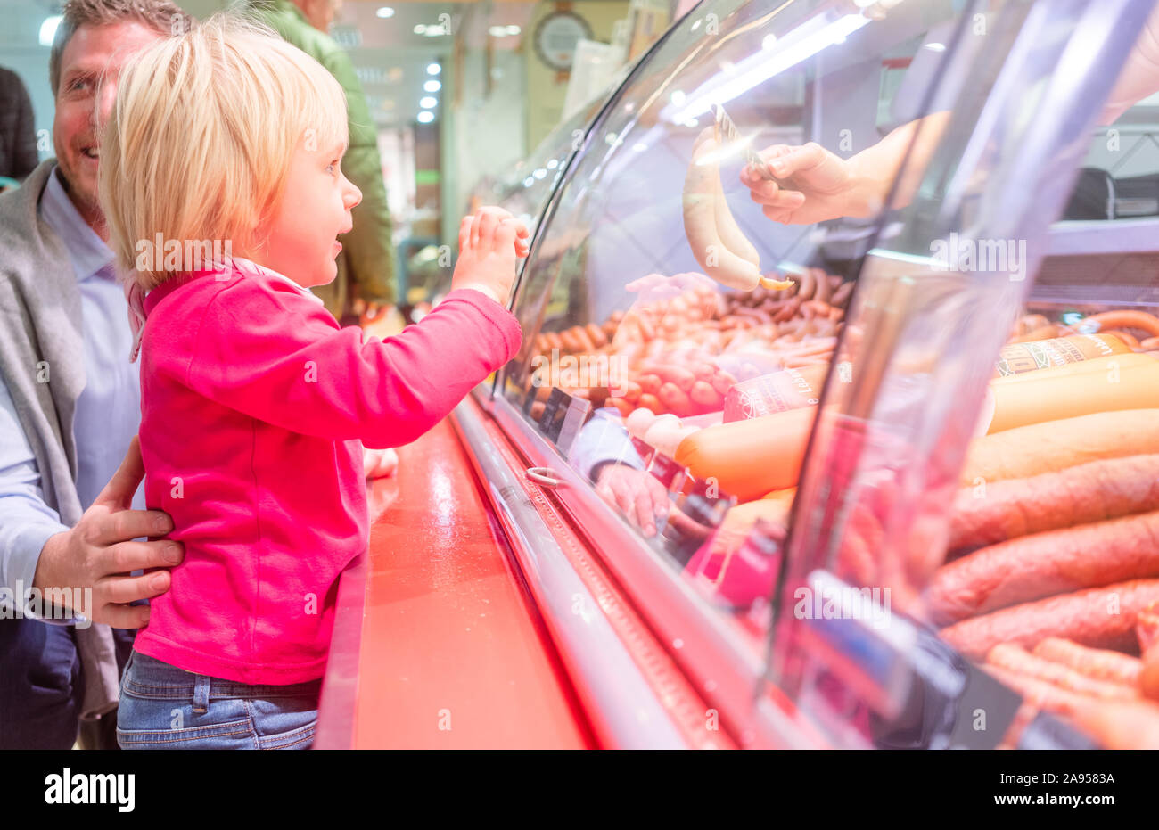 Child in front of the meat counter in a supermarket Stock Photo - Alamy