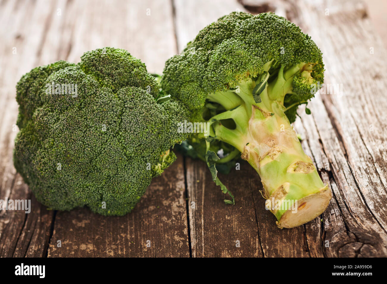 Broccoli, fresh and delicious, resting on an old table, matte style ...